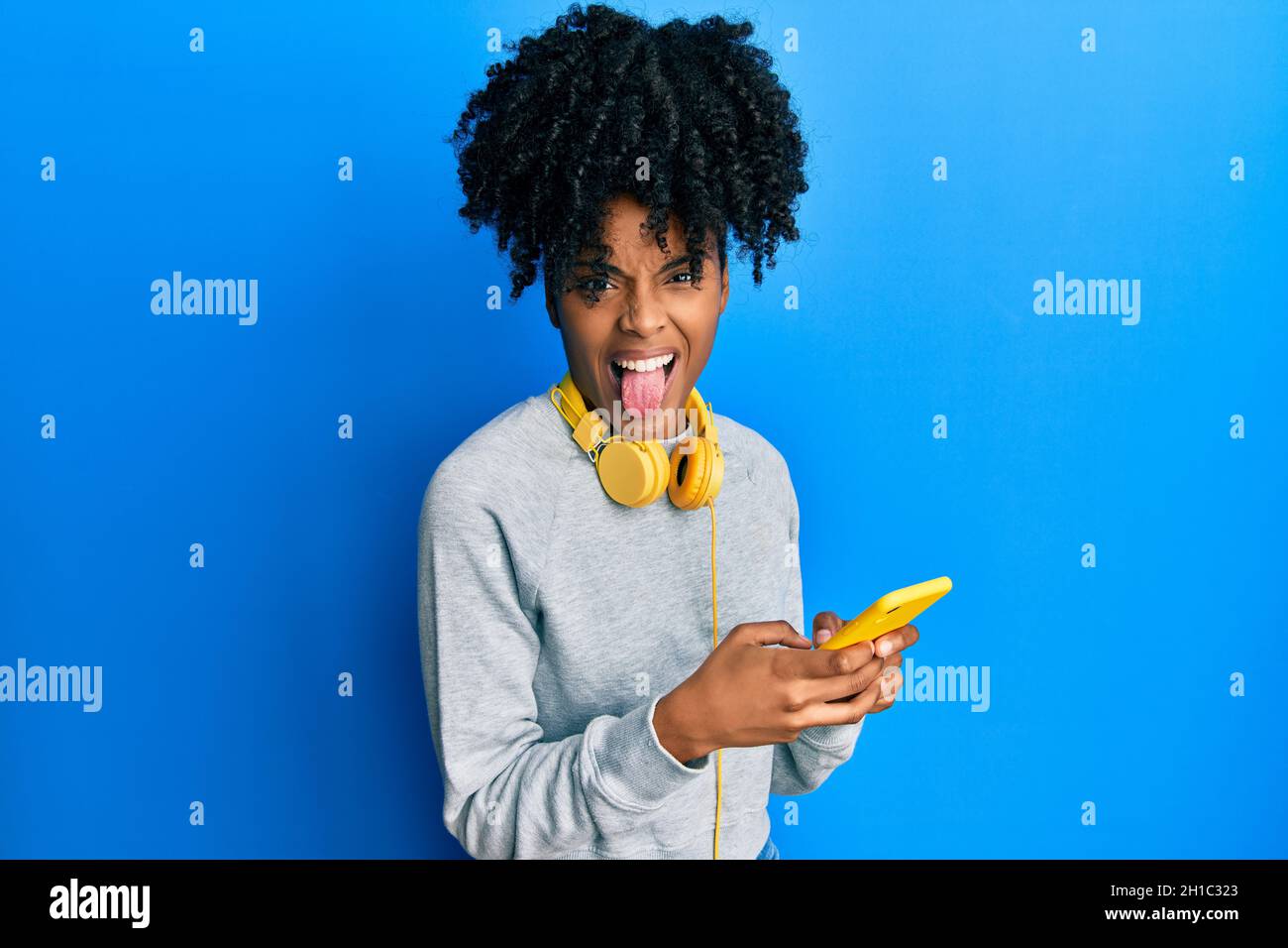 African American Woman With Afro Hair Using Smartphone Typing Message
