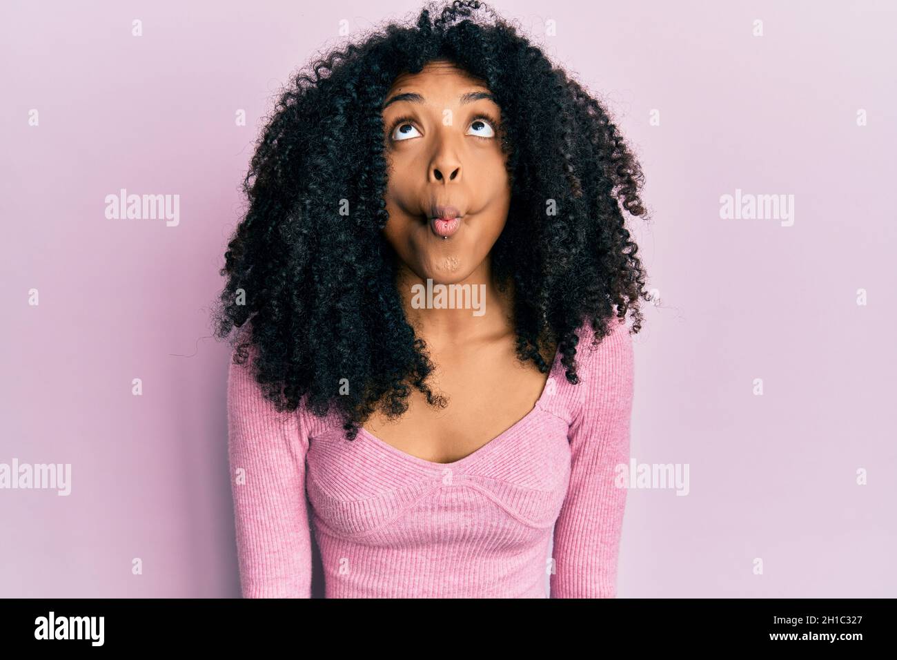 African american woman with afro hair wearing casual pink shirt making ...