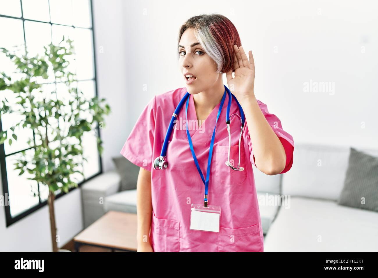 Young beautiful woman wearing doctor uniform and stethoscope smiling ...