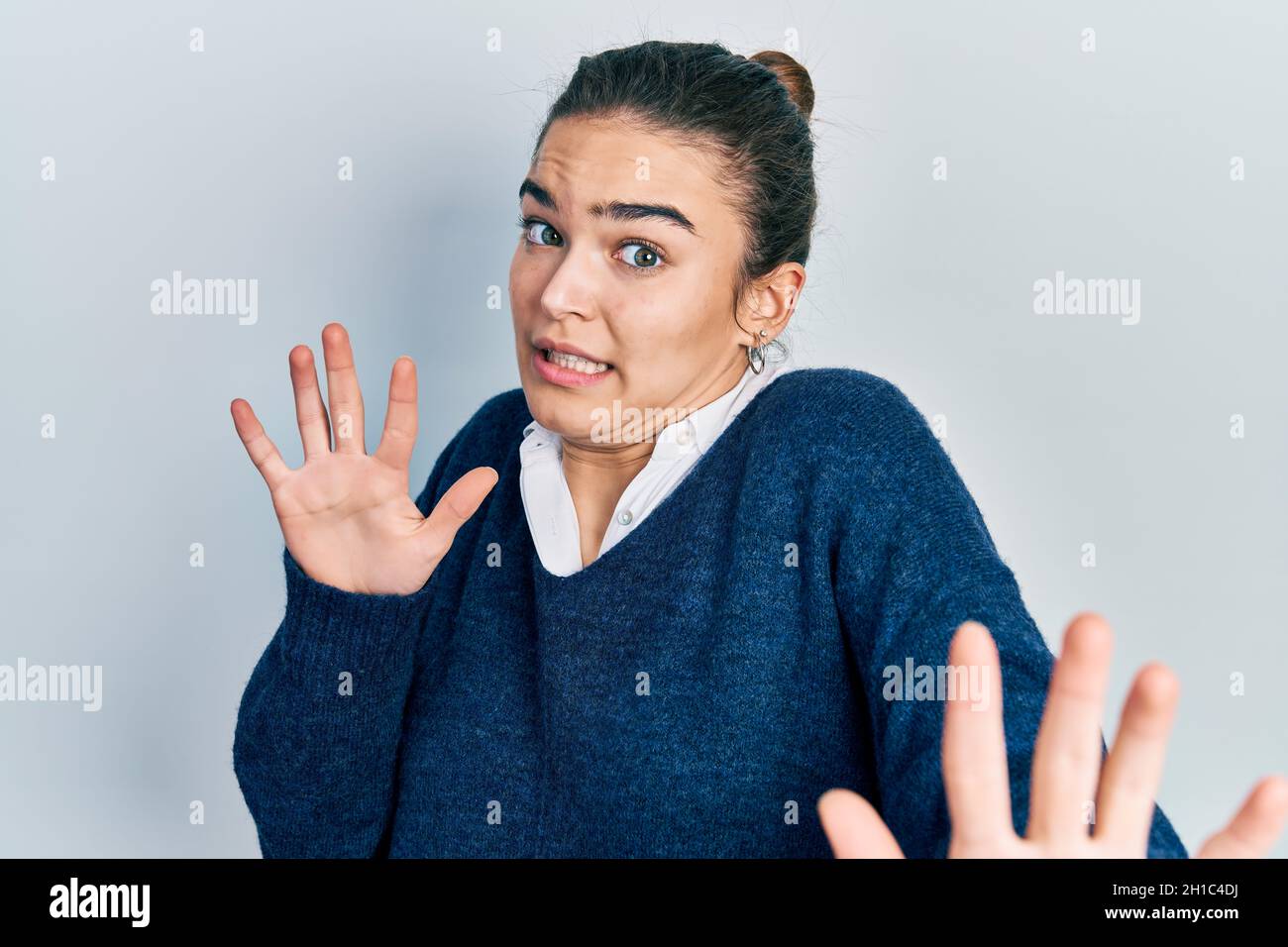 Young caucasian girl wearing casual clothes afraid and terrified with ...