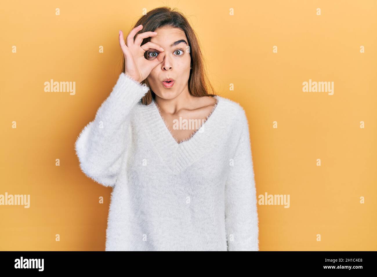 Young caucasian girl wearing casual clothes doing ok gesture shocked ...