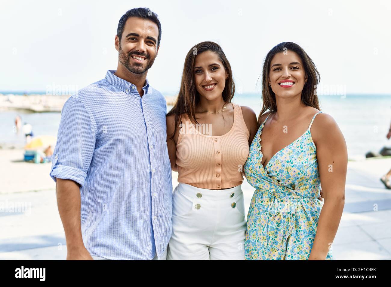 Three young hispanic friends smiling happy standing at the beach Stock ...