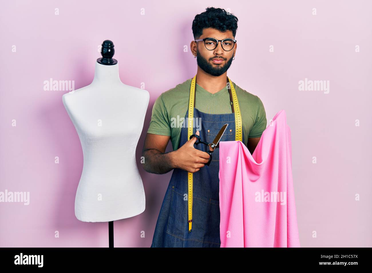 Arab man with beard dressmaker designer holding scissors and cloth ...