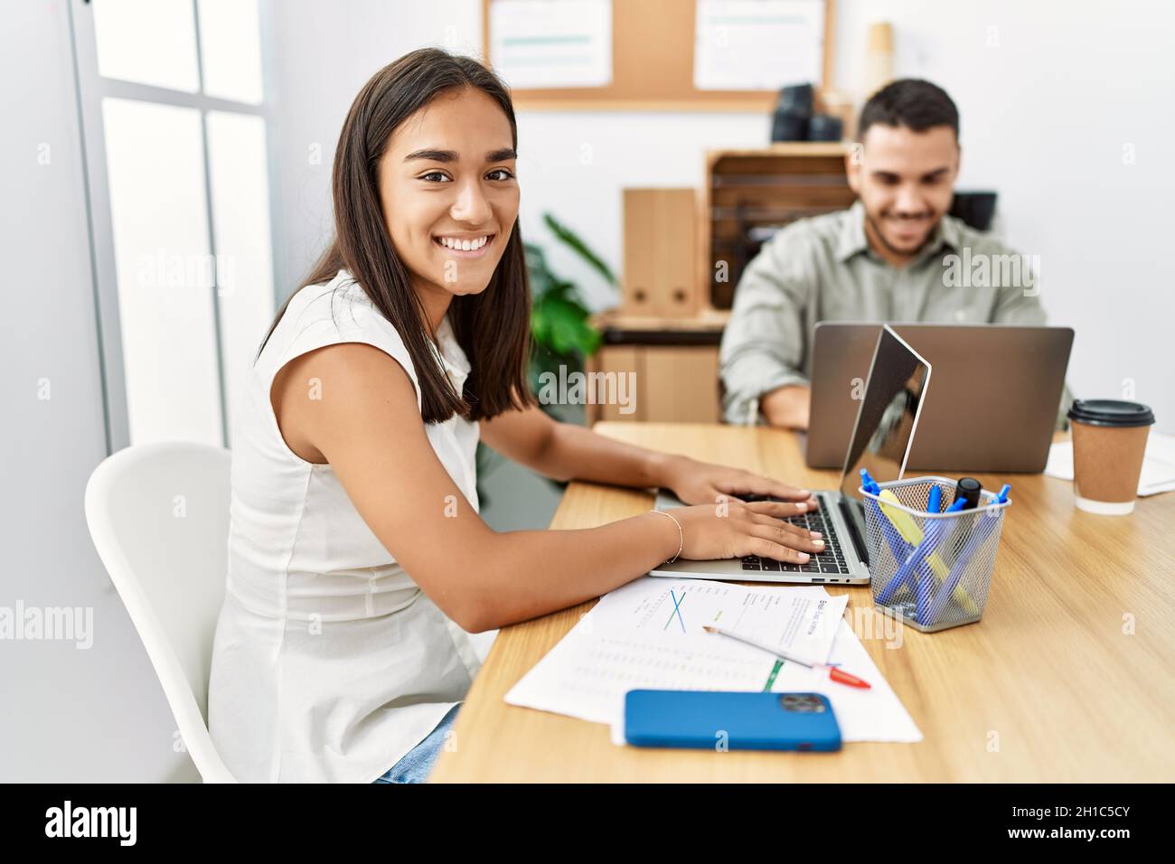 Two latin business workers smiling happy working at the office Stock ...