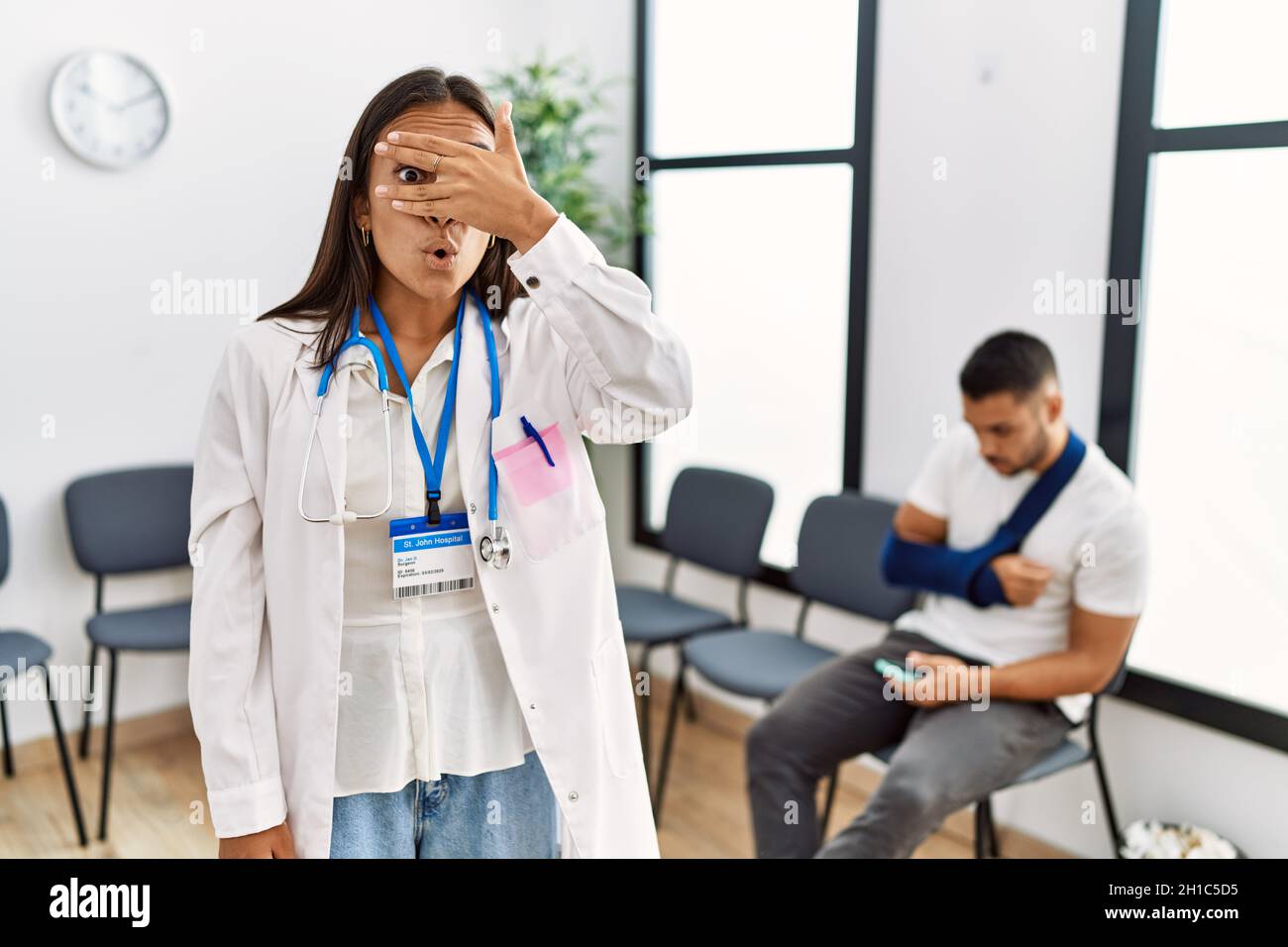 Young asian doctor woman at waiting room with a man with a broken arm ...