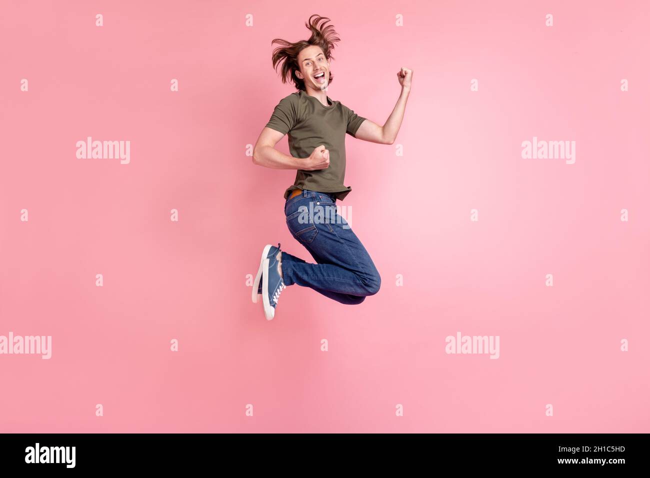 Full size profile side photo of young guy happy positive smile jump up ...