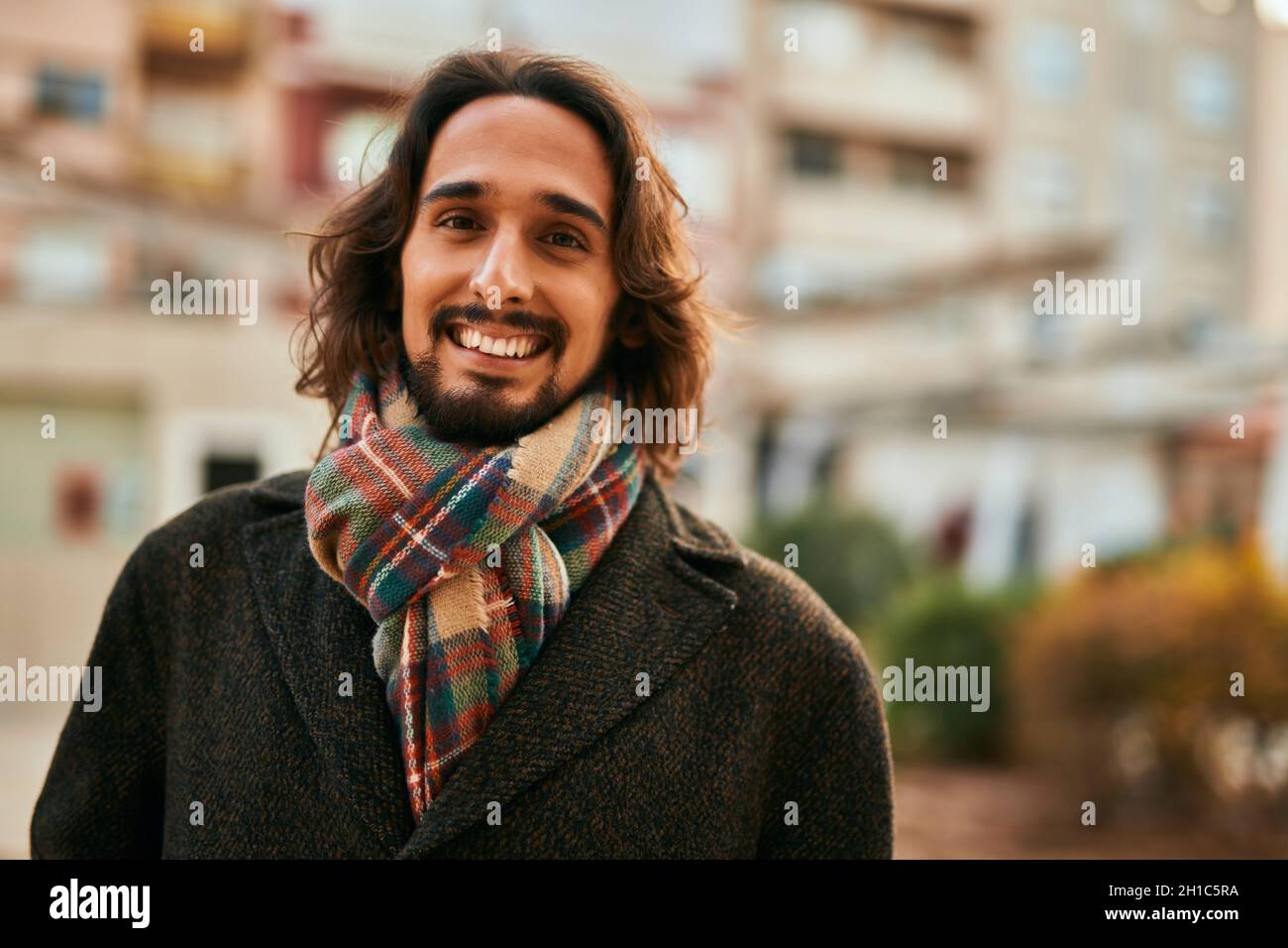 Young hispanic man smiling happy standing at the city Stock Photo - Alamy