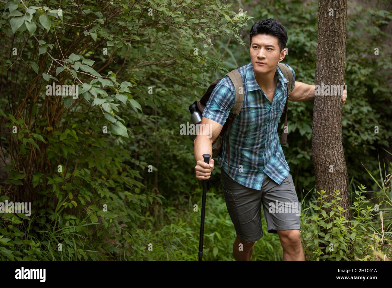 Young man hiking outdoors Stock Photo - Alamy
