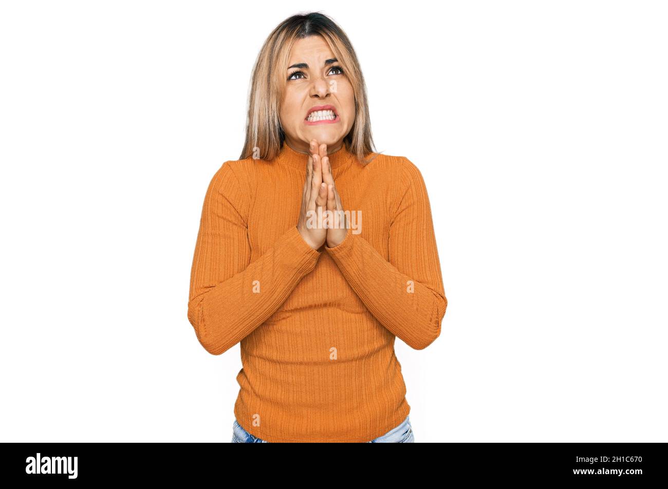Young caucasian woman wearing casual clothes begging and praying with ...