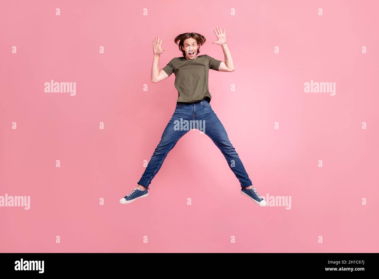 Full body photo of young cheerful man jump fly casual outfit wave hello ...