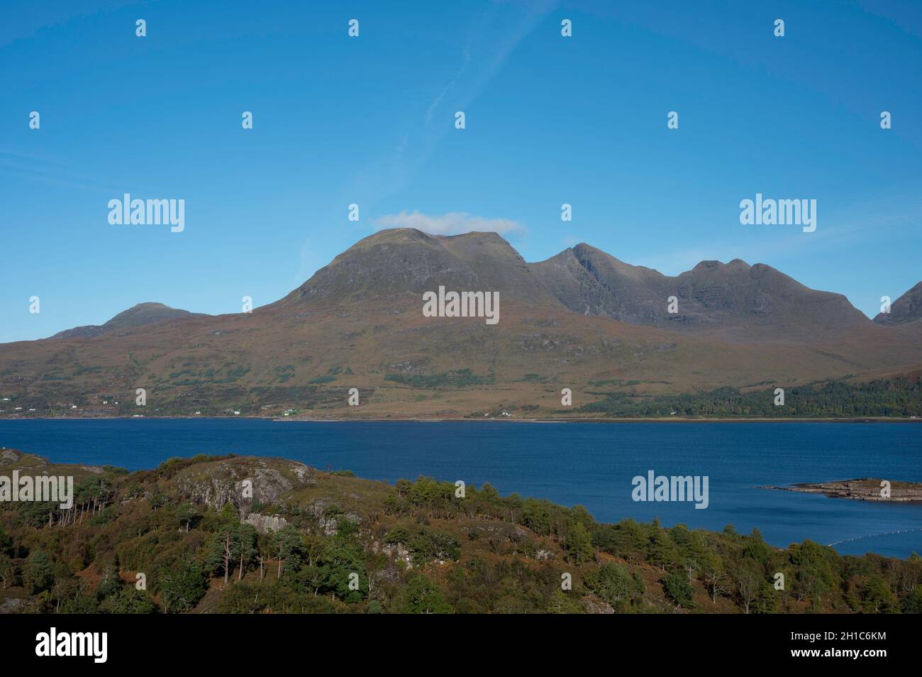 View over forest and Loch Torridon to Beinn Alligin mountain in the ...