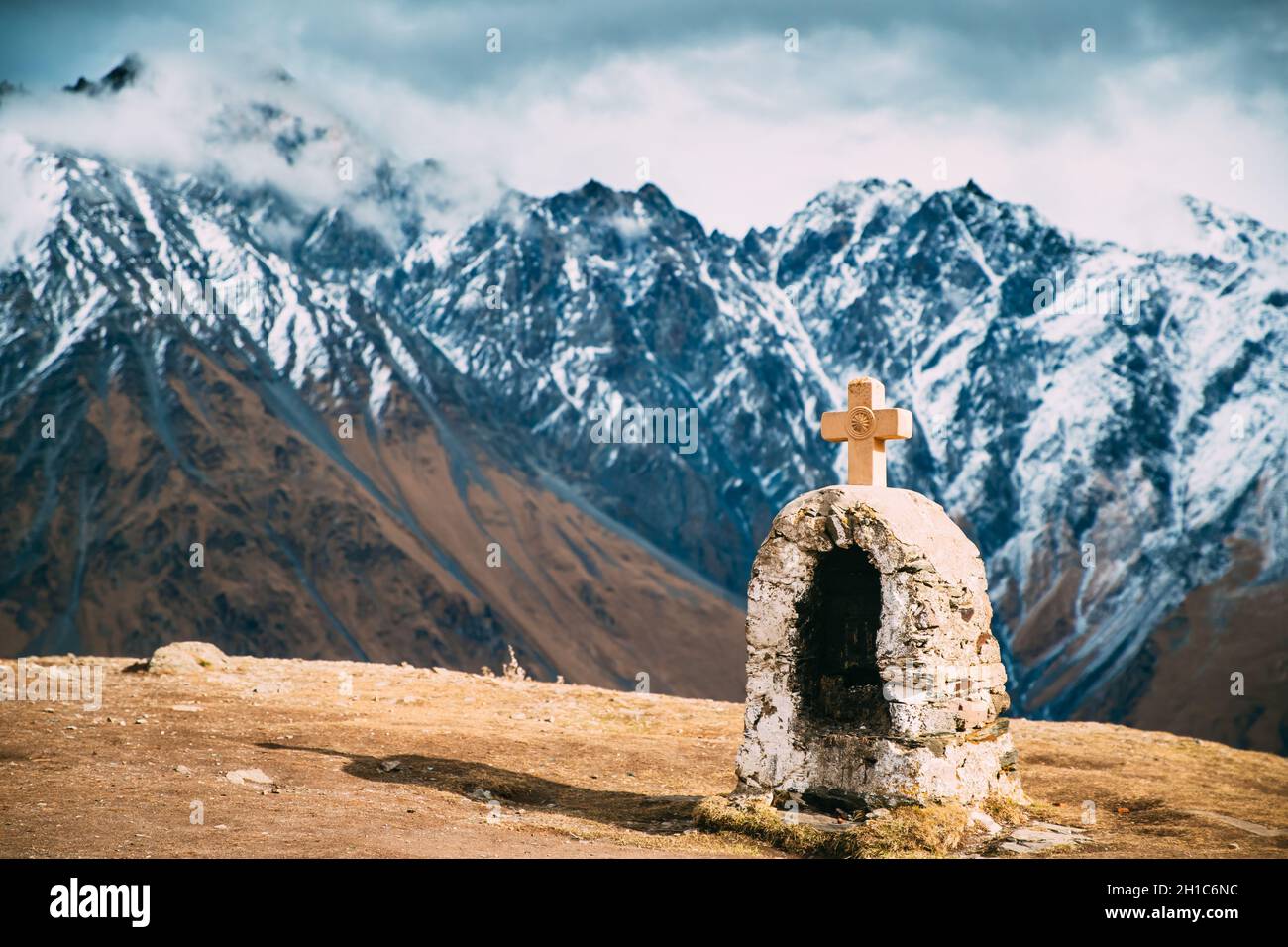 Stepantsminda, Georgia. Cross On Stones On Mountains Background Stock ...