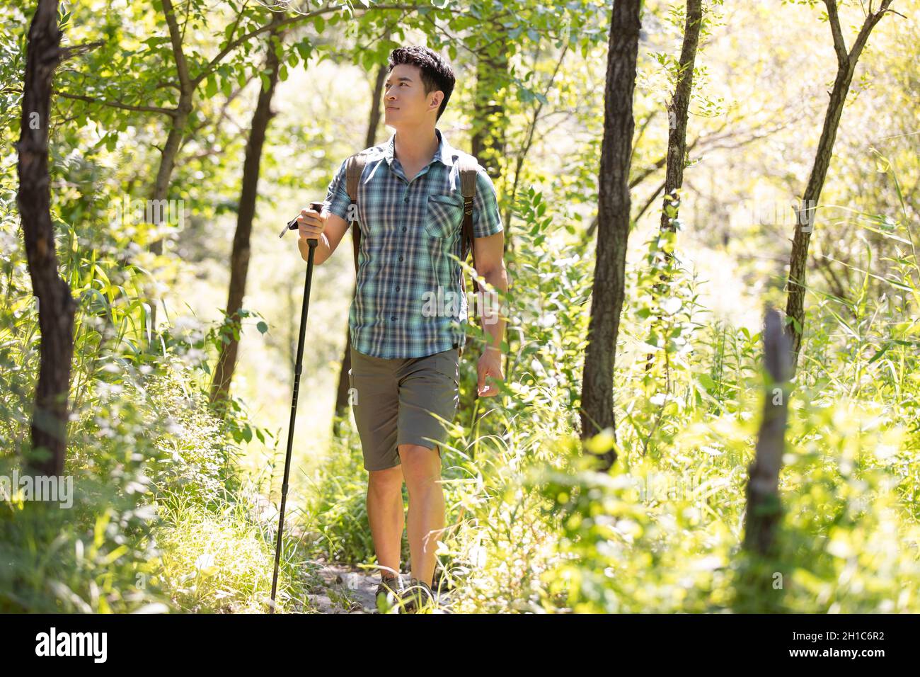Happy young man hiking outdoors Stock Photo - Alamy