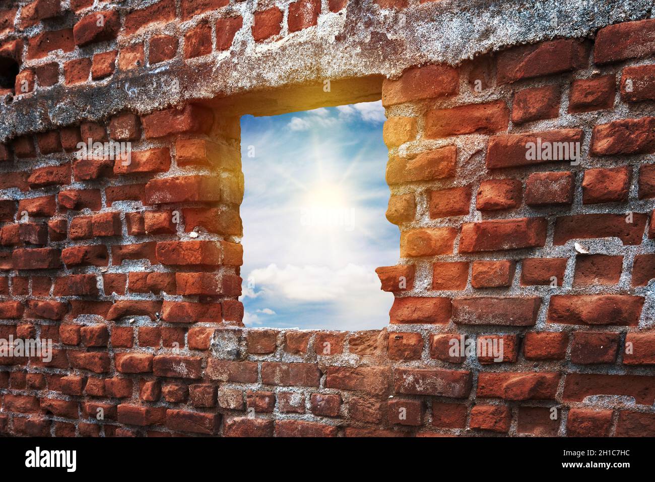 Ruined old brick building with broken window with sun, sky and ...