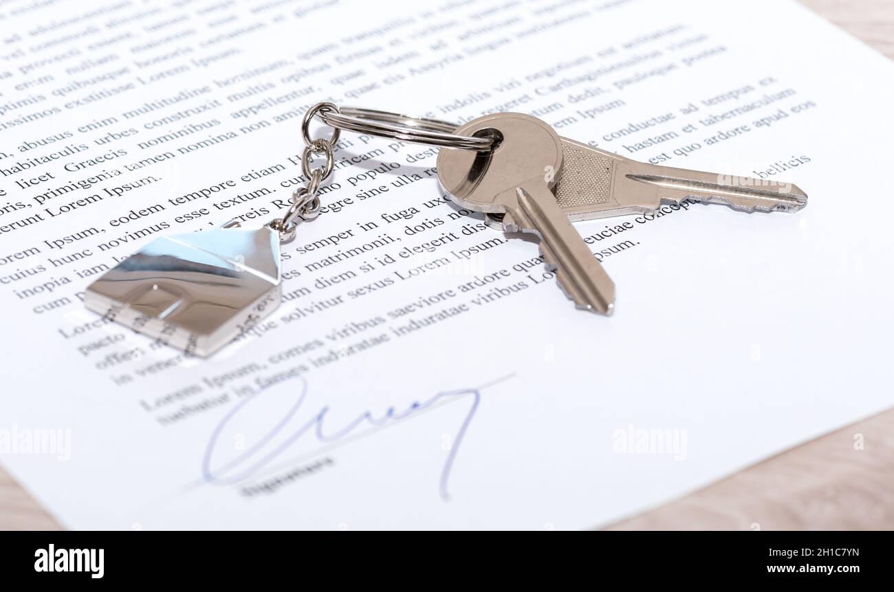 Closeup of house keys on a signed contract Stock Photo - Alamy