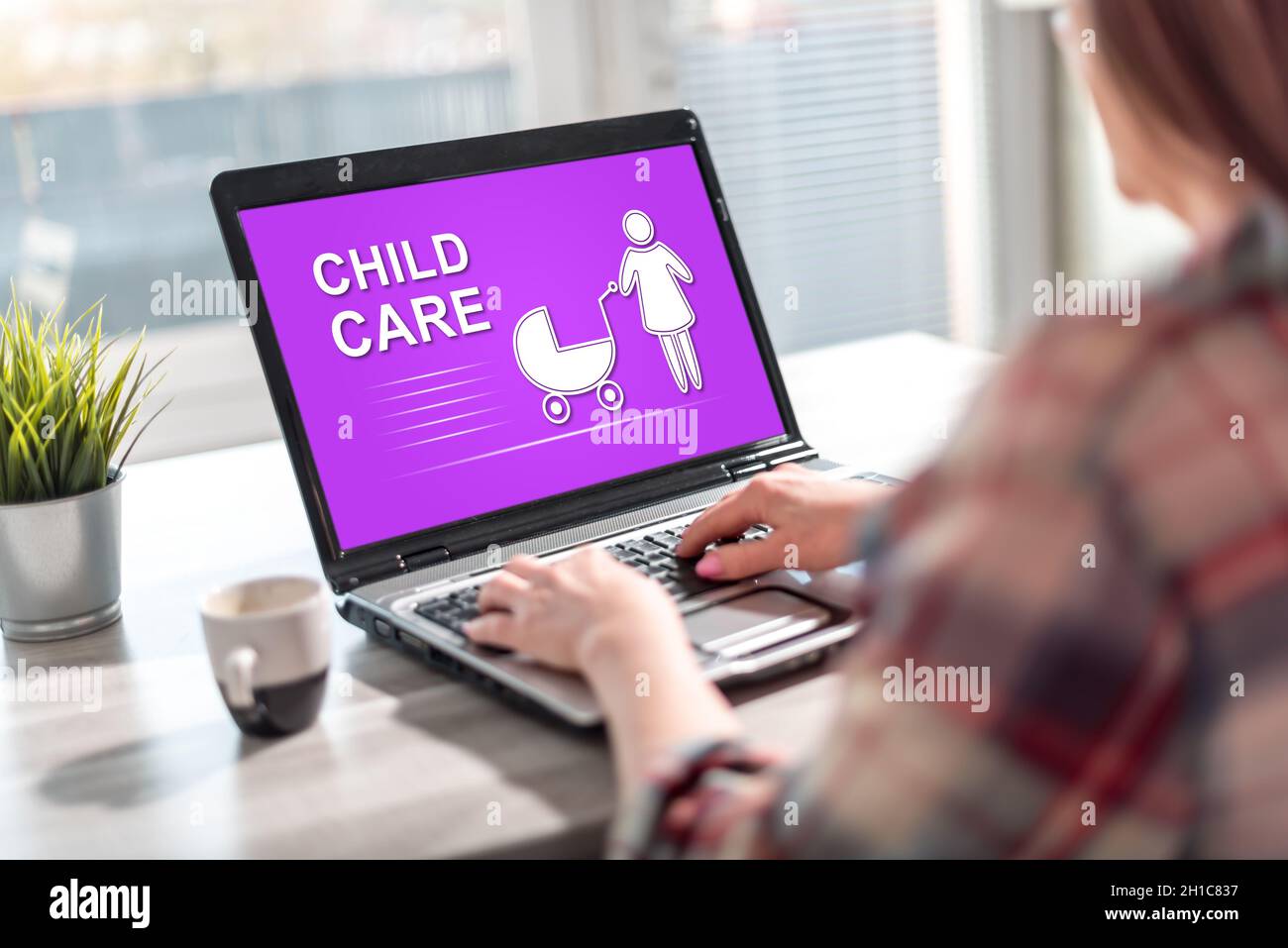 Laptop screen displaying a child care concept Stock Photo - Alamy