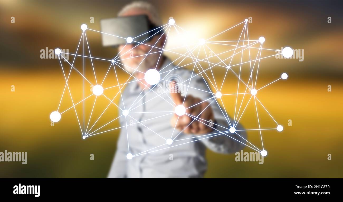 Man wearing a reality virtual headset touching a virtual network on a ...