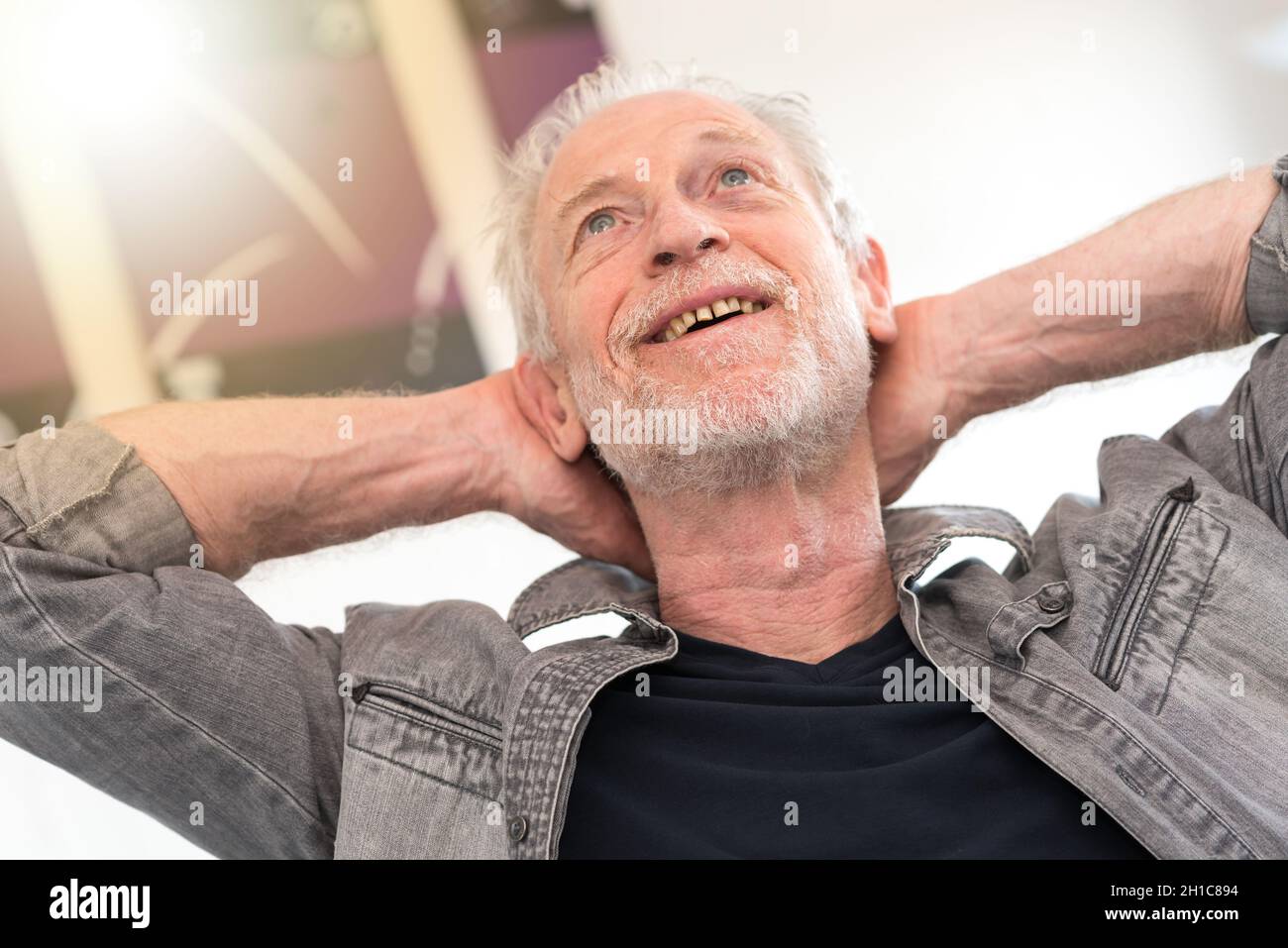 Relaxed mature man daydreaming, light effect Stock Photo - Alamy