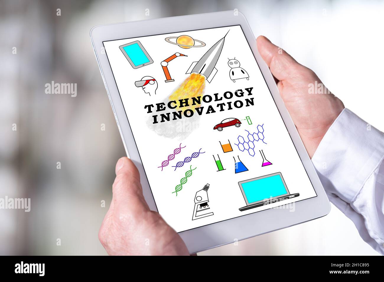 Man holding a tablet showing technology innovation concept Stock Photo ...