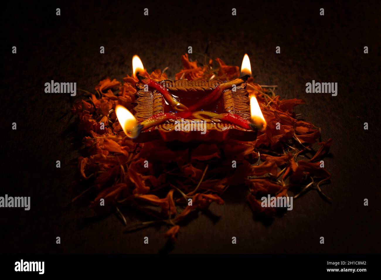 diya in flower petals during Diwali Stock Photo - Alamy
