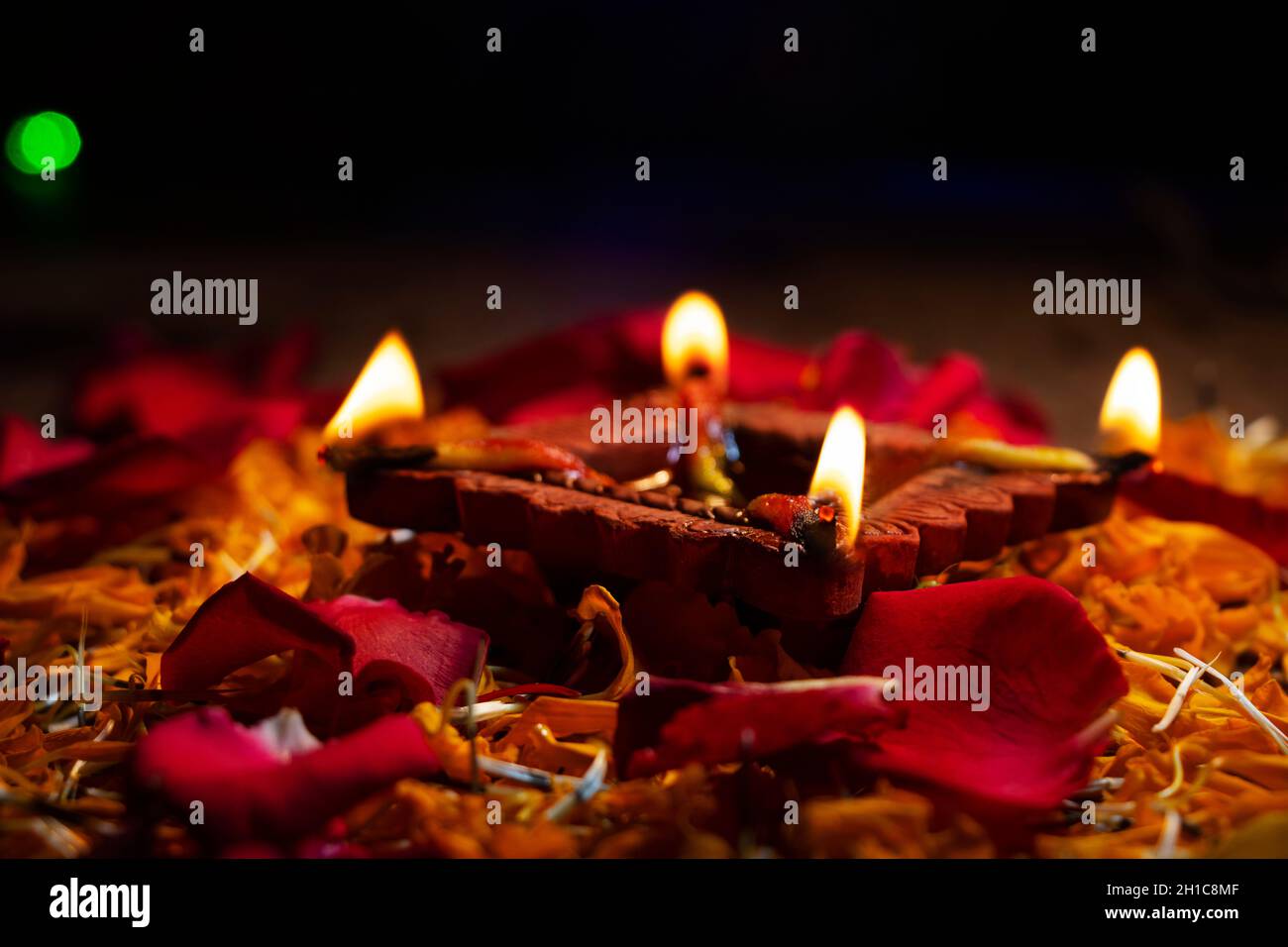 diya in flower petals during Diwali Stock Photo - Alamy