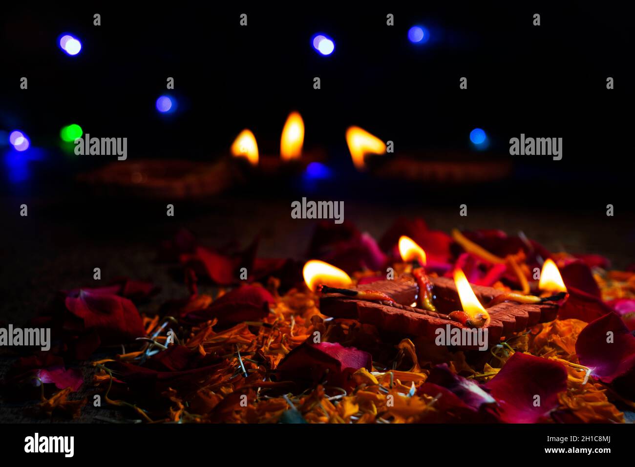 diya in flower petals during Diwali Stock Photo - Alamy