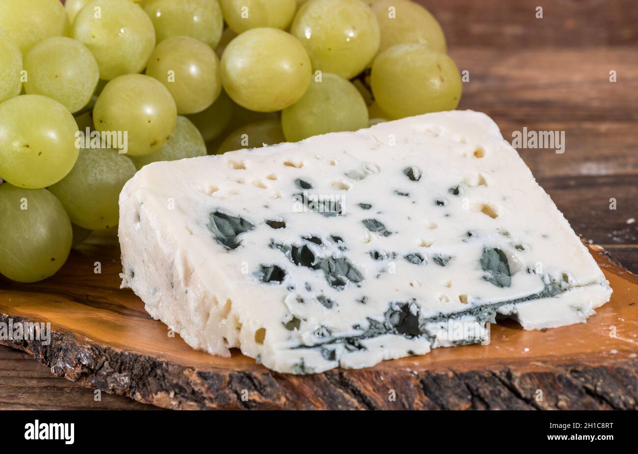French roquefort cheese with white grapes on wooden background Stock Photo - Alamy