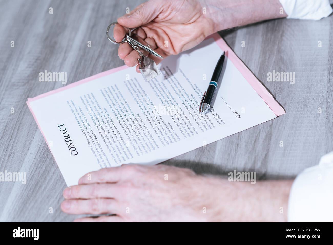 Signature of a real estate contract (Lorem ipsum text used Stock Photo ...