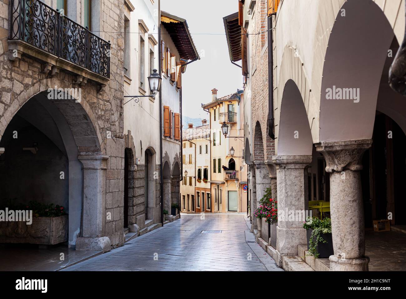 View of the Gemona Street with the typical arches of old town city ...