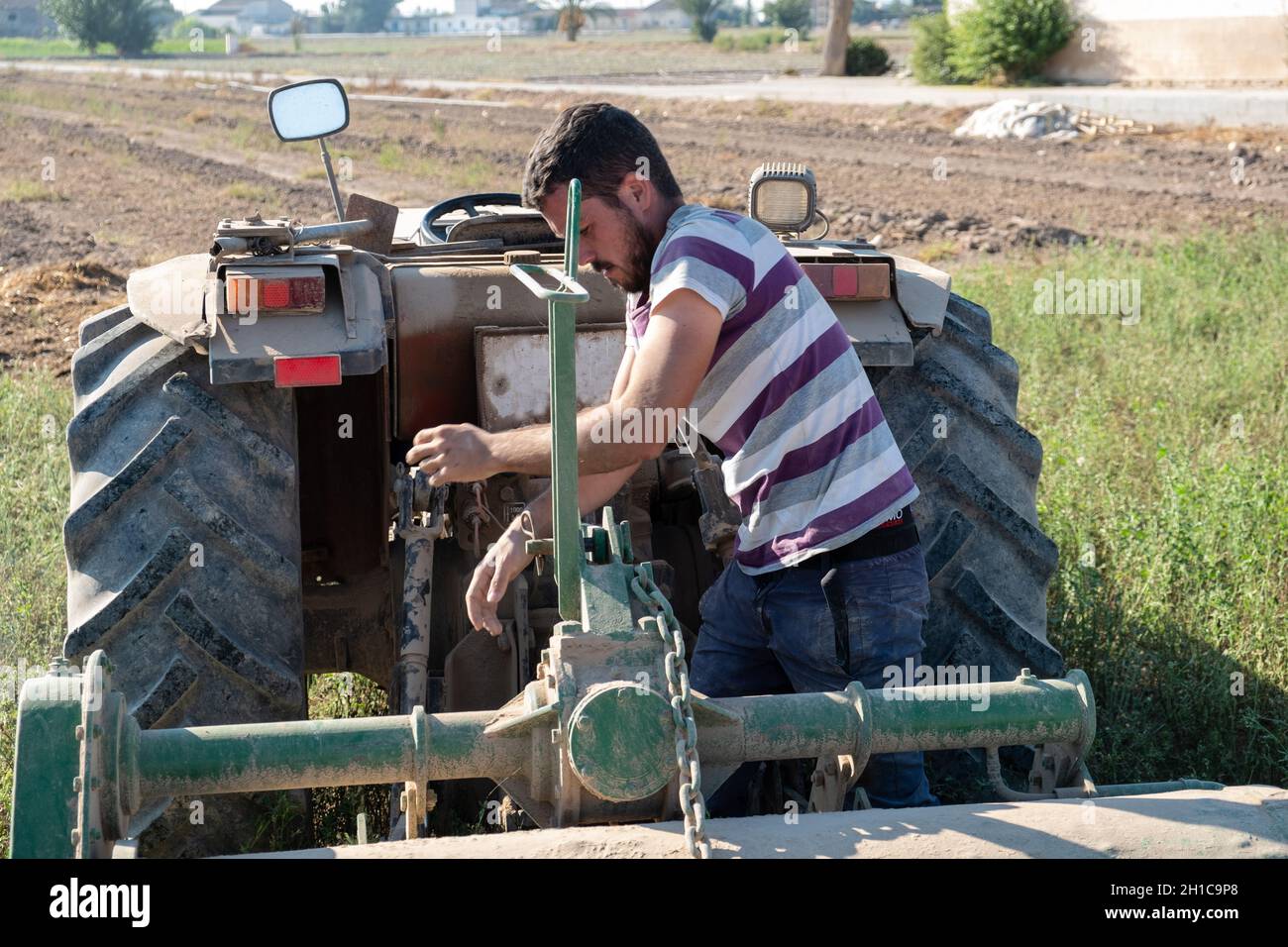 young farmer preparing the farm tools to start the cultivation of the ...