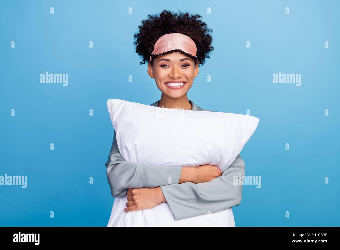 Photo of young cheerful african lady hug pillow blindfold sleepover bed ...