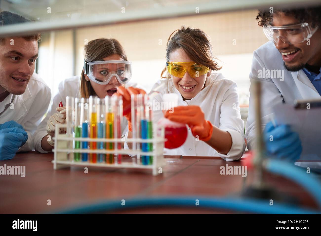 Young excited chemistry students in a relaxed atmosphere in a ...