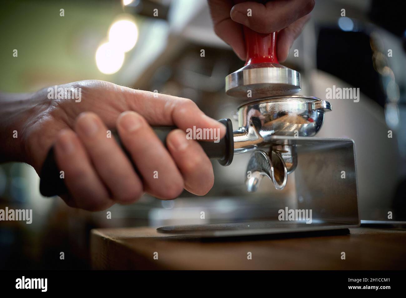 A measure of fragrant and aromatic ground coffee being pressed for ...