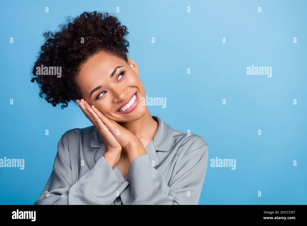 Photo of young cheerful afro girl hands touch cheek dream wondered look ...