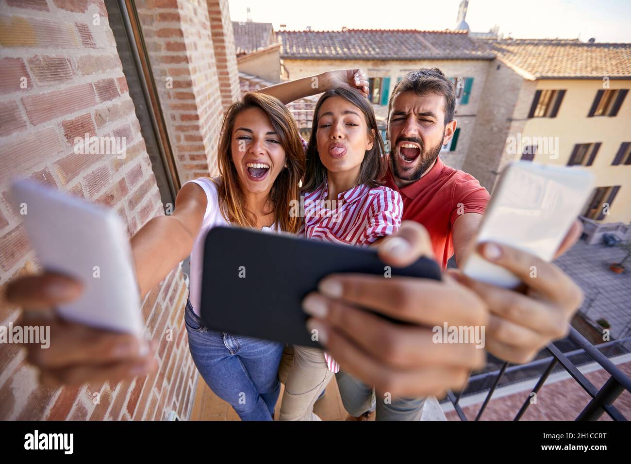 Group of young people making funny selfie together Stock Photo - Alamy