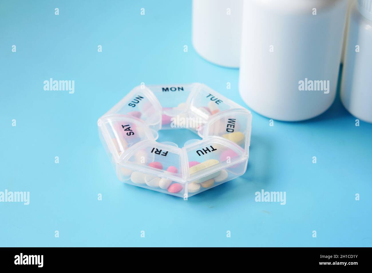 pill box and medical pill container on blue Stock Photo - Alamy