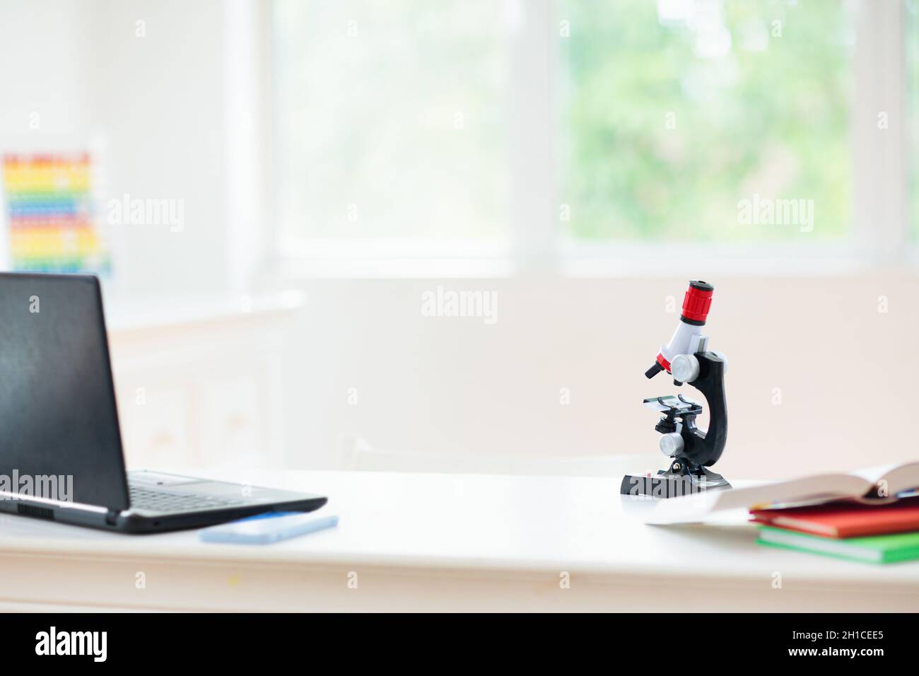 School desk with microscope. Science class. Children making biology or ...