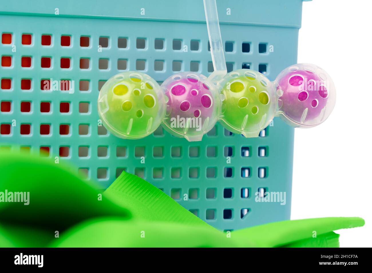 Toilet cleaning detergent balls and plastic basket on white background ...
