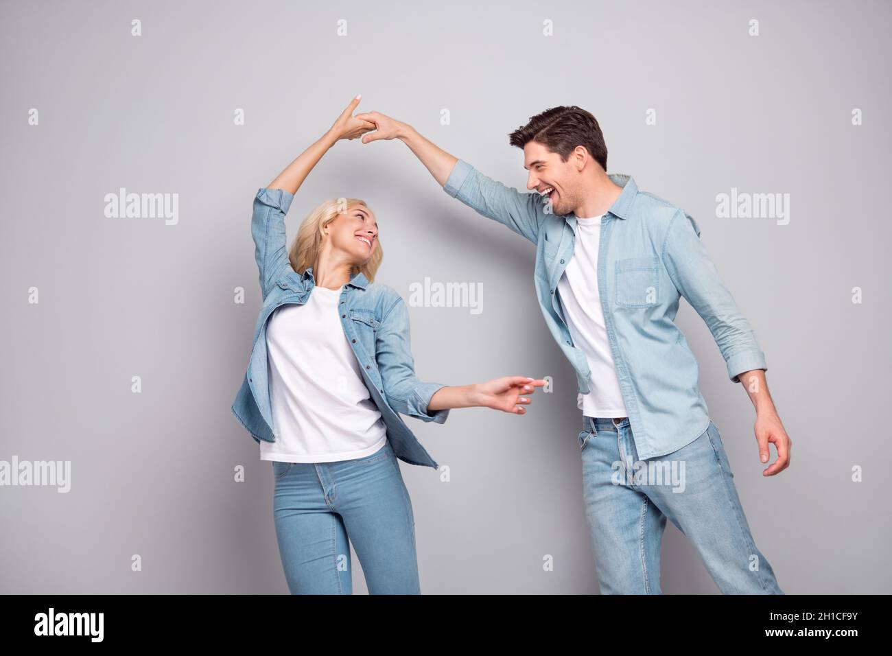 Portrait of attractive cheerful couple dancing having fun pastime ...
