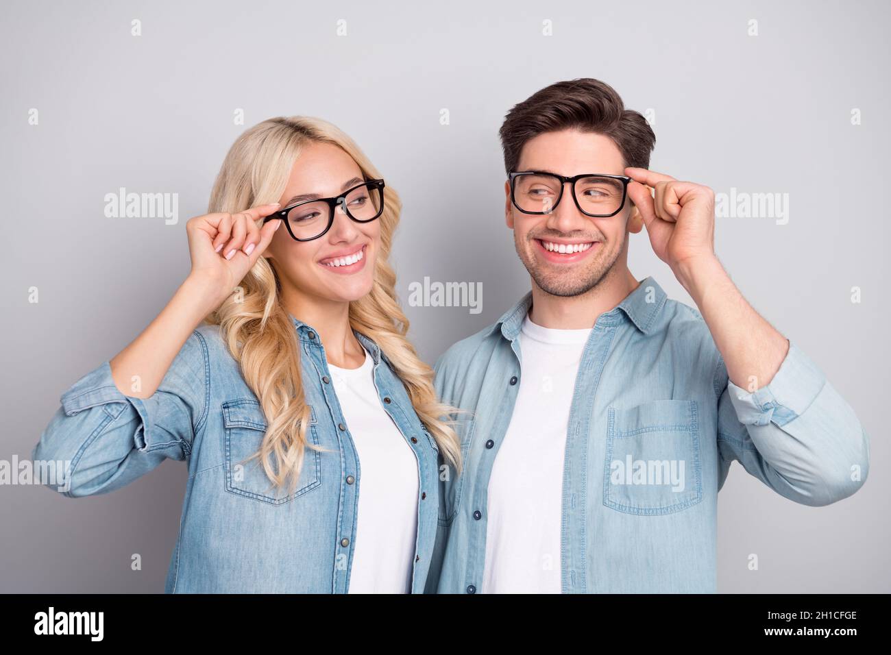 Portrait of attractive cheerful couple touching specs good mood ...
