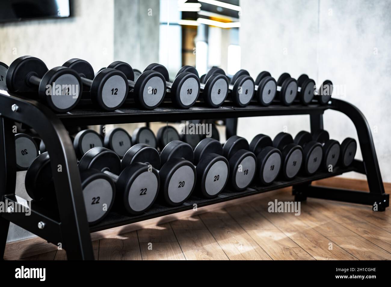 Row of dumbells with hand hi-res stock photography and images - Alamy