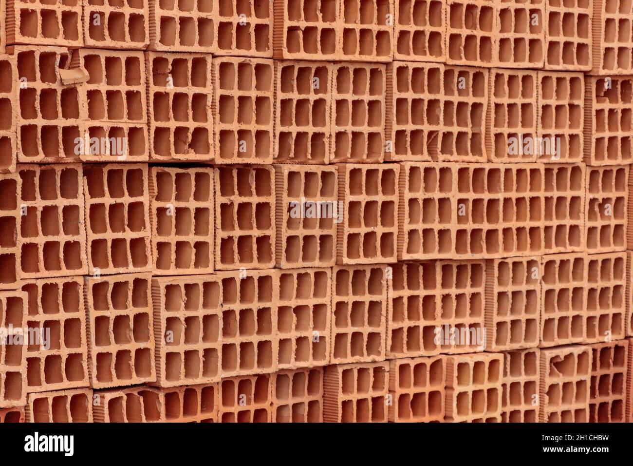 Pile of clay bricks used for building masonry house. The image shows ...
