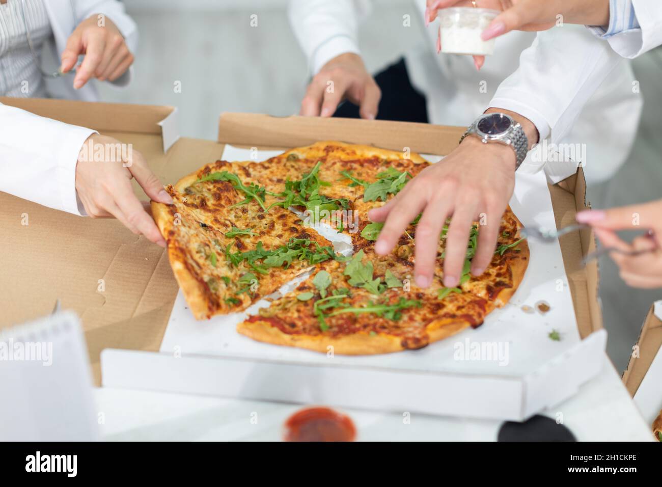 Female doctor eating pizza hi-res stock photography and images - Alamy