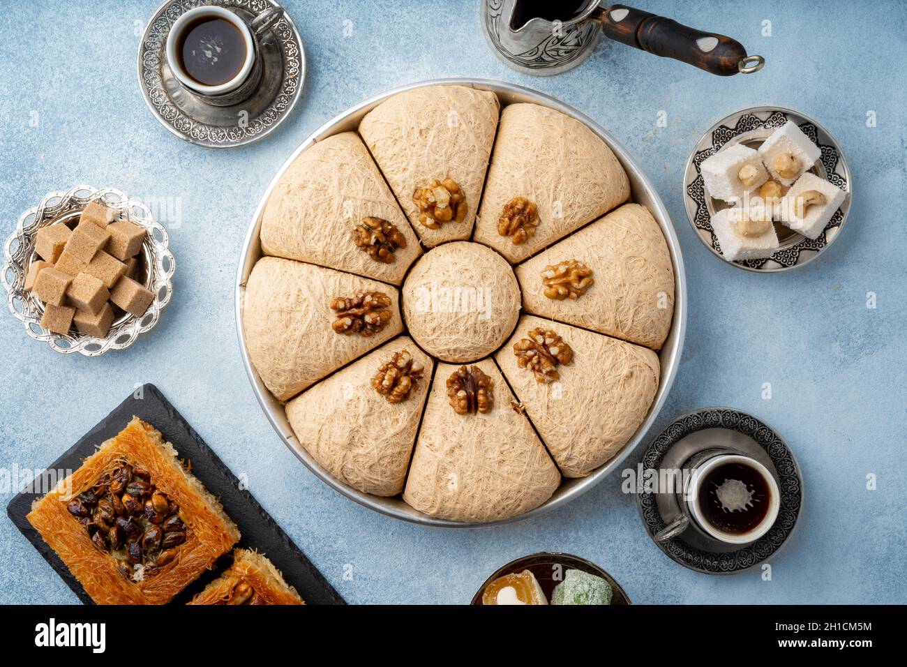Top view of Turkish sweets and turkish coffee on light blue background ...