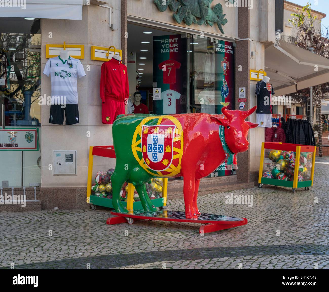 Statue of a cow in the colours of the Portuguese flag, in the city of ...