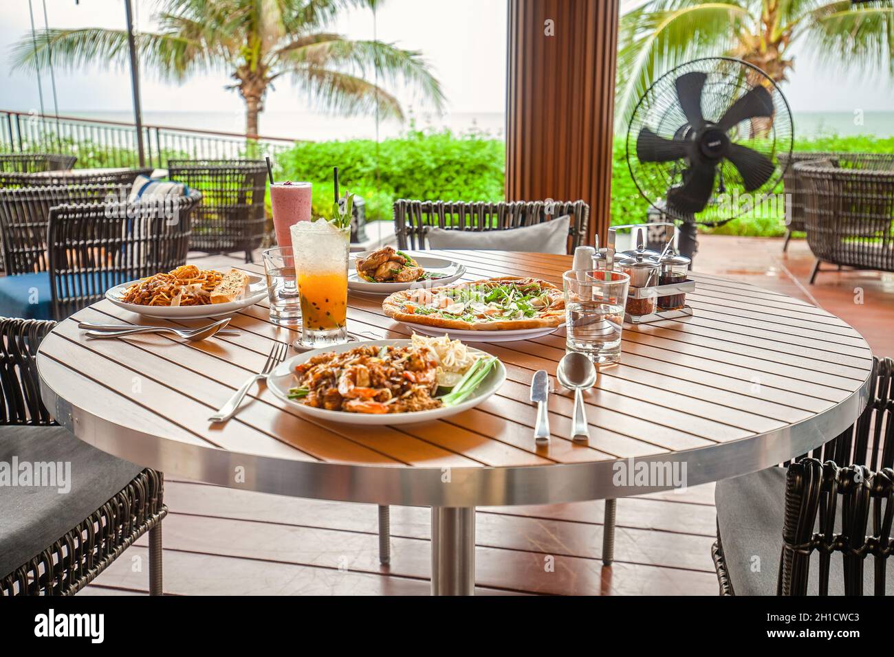 Table with food and cocktails in outdoor restaurant in tropical resort ...