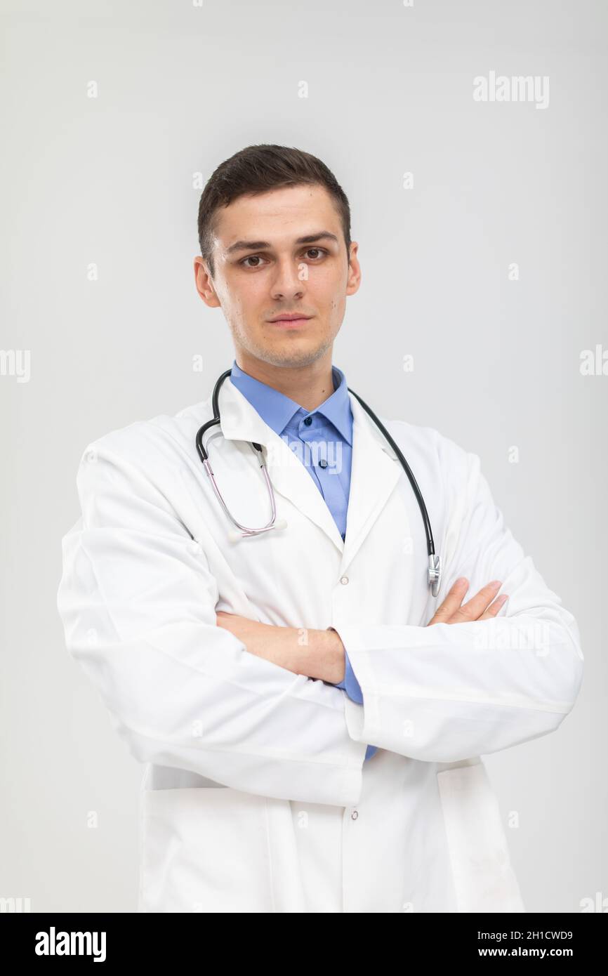 The doctor stands forward with folded arms with a gentle smile Stock ...
