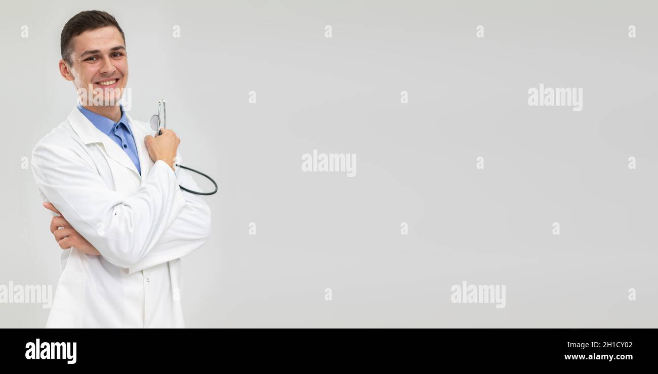 The doctor is facing the camera and holding a stethoscope in his hand ...
