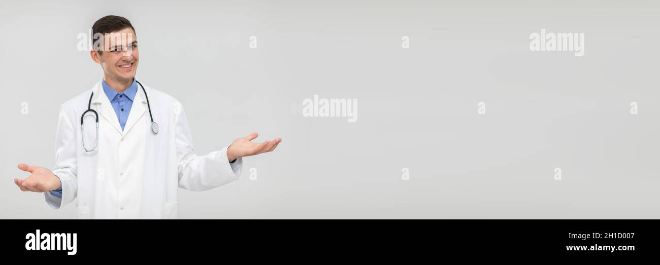 A smiling doctor spreads his arms out to the sides and leaves the ...