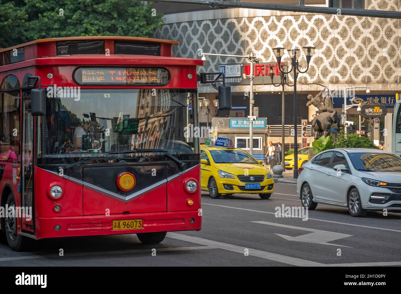 Chongqing, China - August 2019 : Red public bus driving on the busy and ...